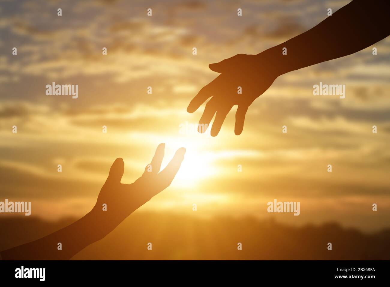 Silhouette of giving a helping hand, hope and support each other over ...
