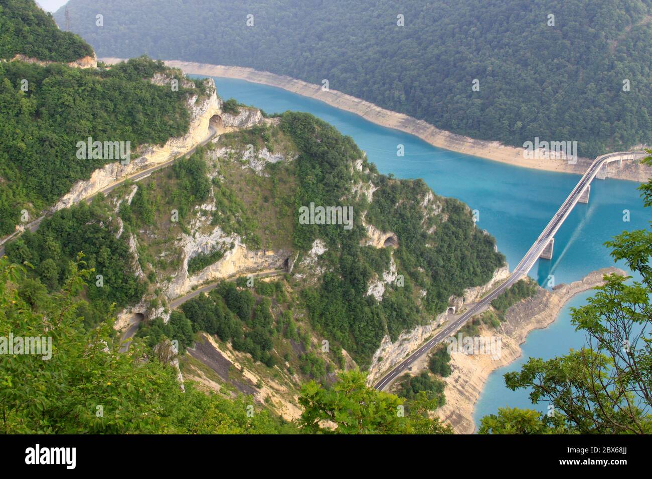 Descending road and bridge at Piva Lake (Pivsko Jezero) reservoir in ...