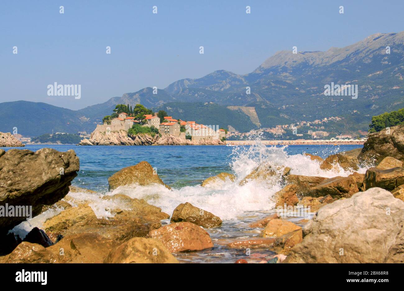 Sveti Stefan island and waves of sea, Montenegro. Saint Stephen island ...