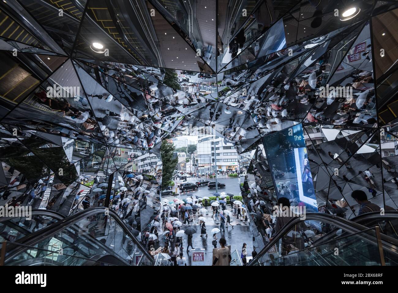 Tokyo, Japan - Septemper 29, 2018: People are seen reflected in a ...