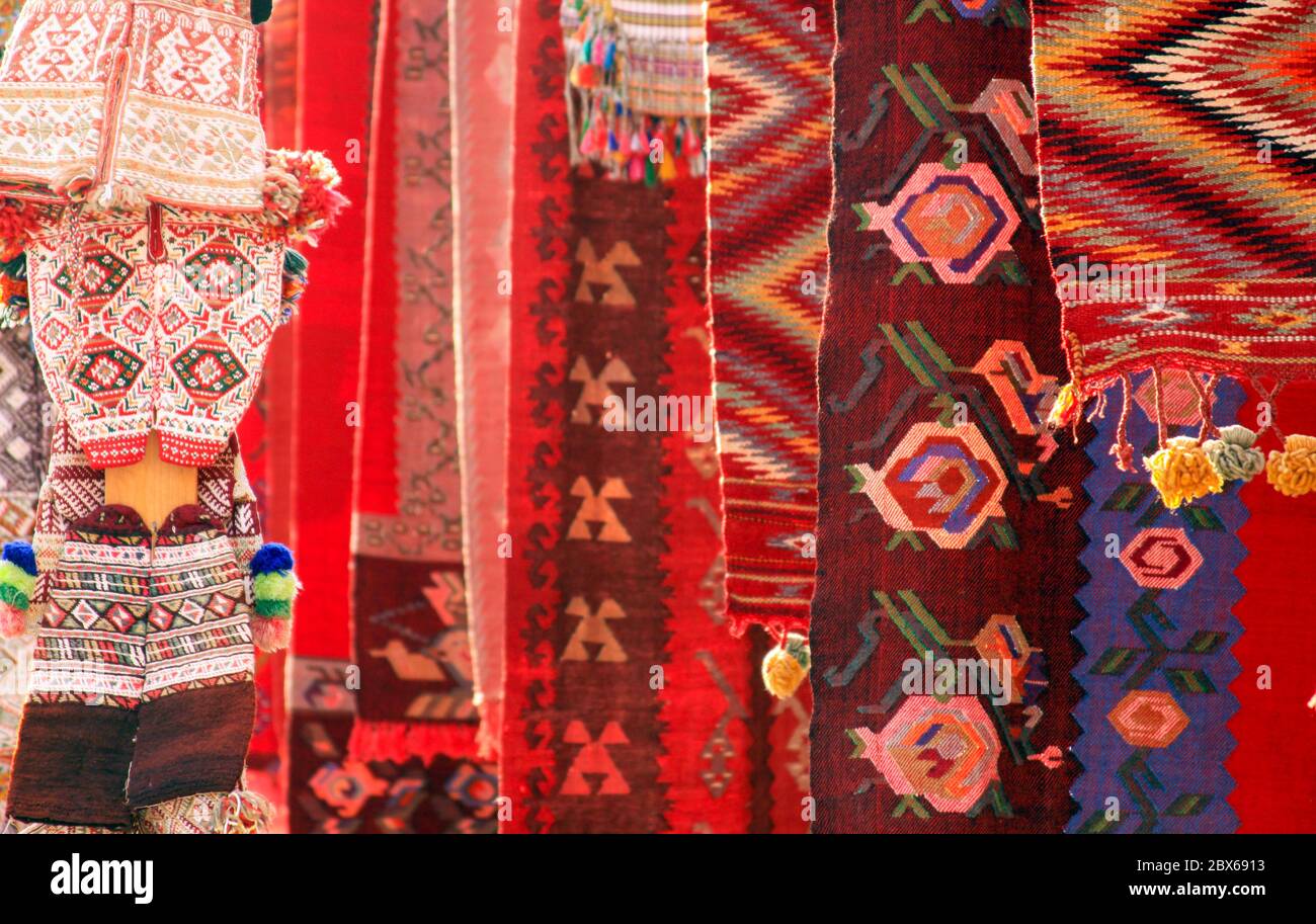 Red carpets and clothing souvenirs in Skopje, Macedonia. Detail view of ...