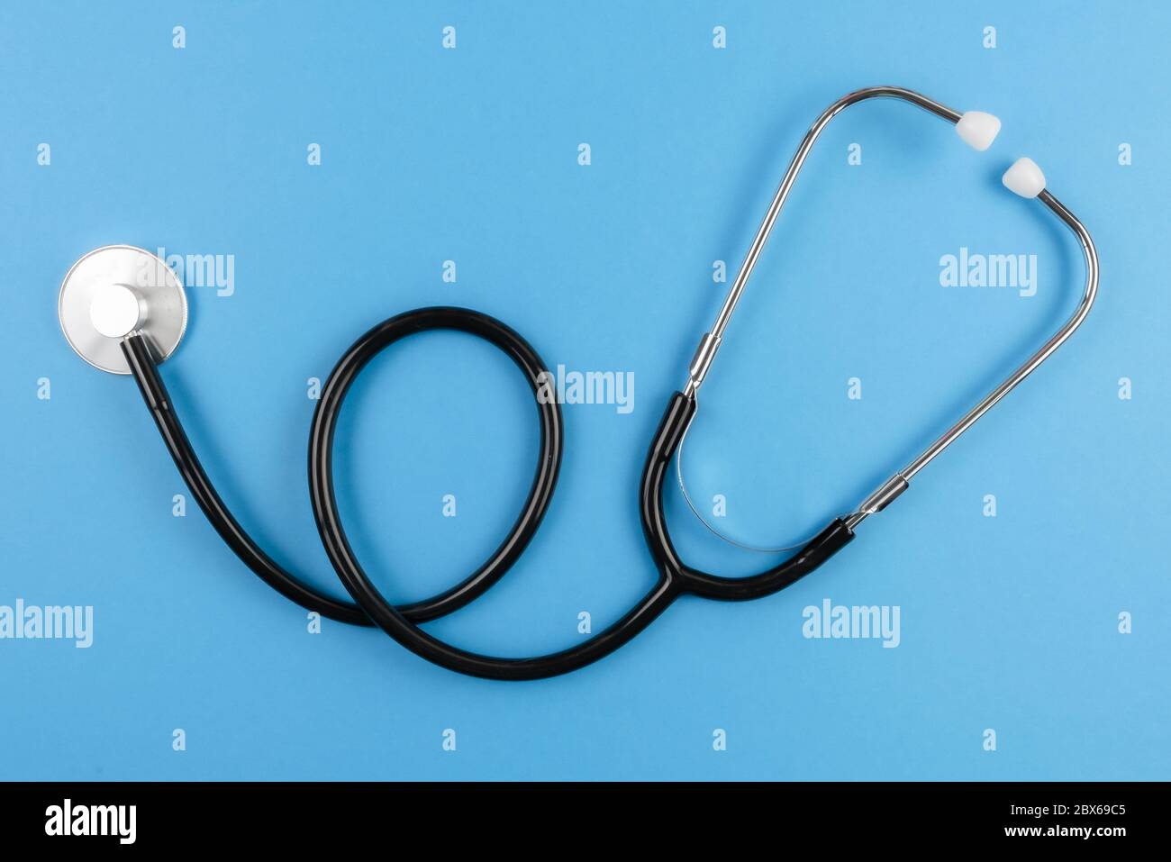 close-up top view of stethoscope on blue background Stock Photo - Alamy
