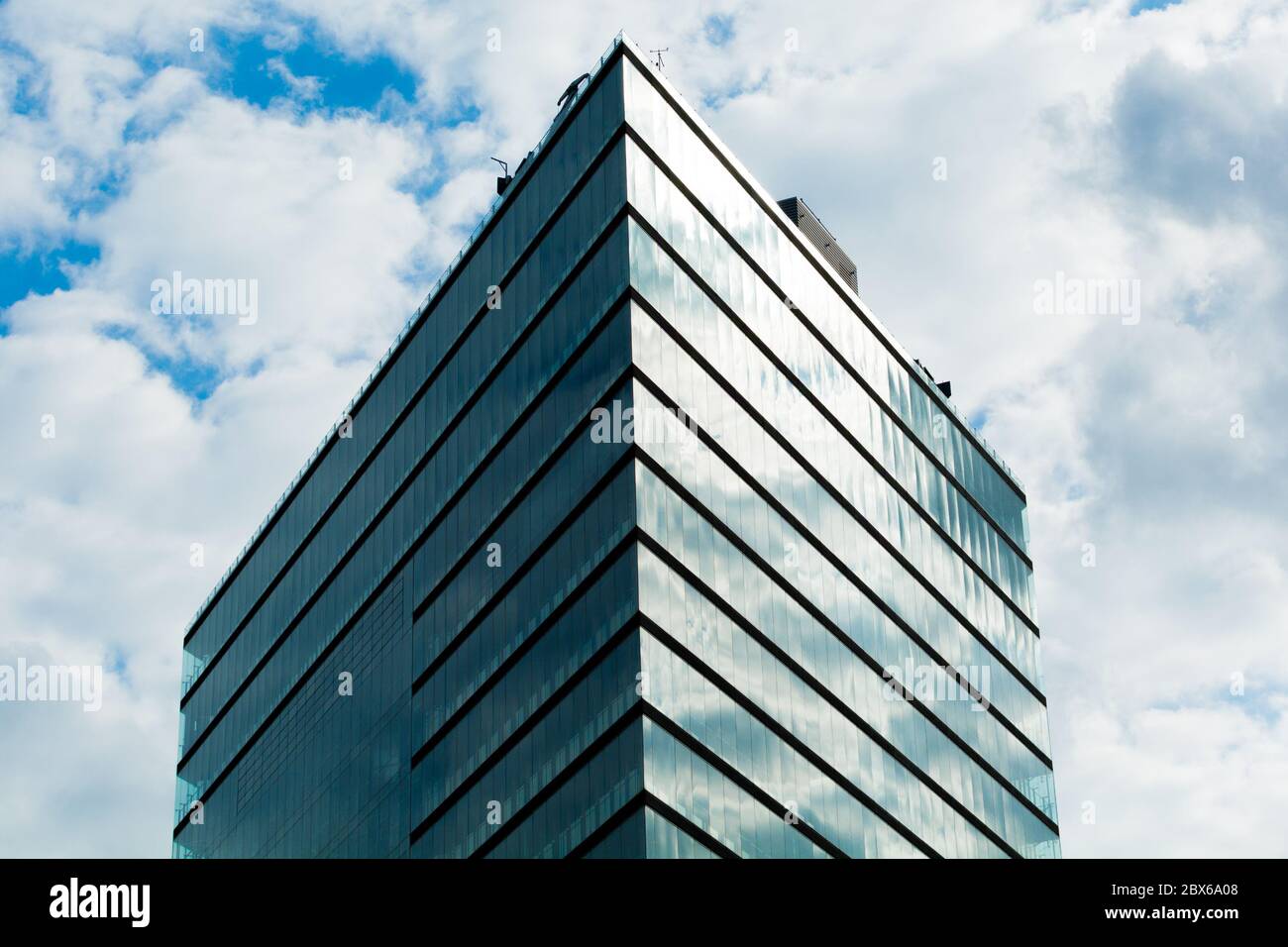 A shiny office building with a light and a dark side Stock Photo - Alamy