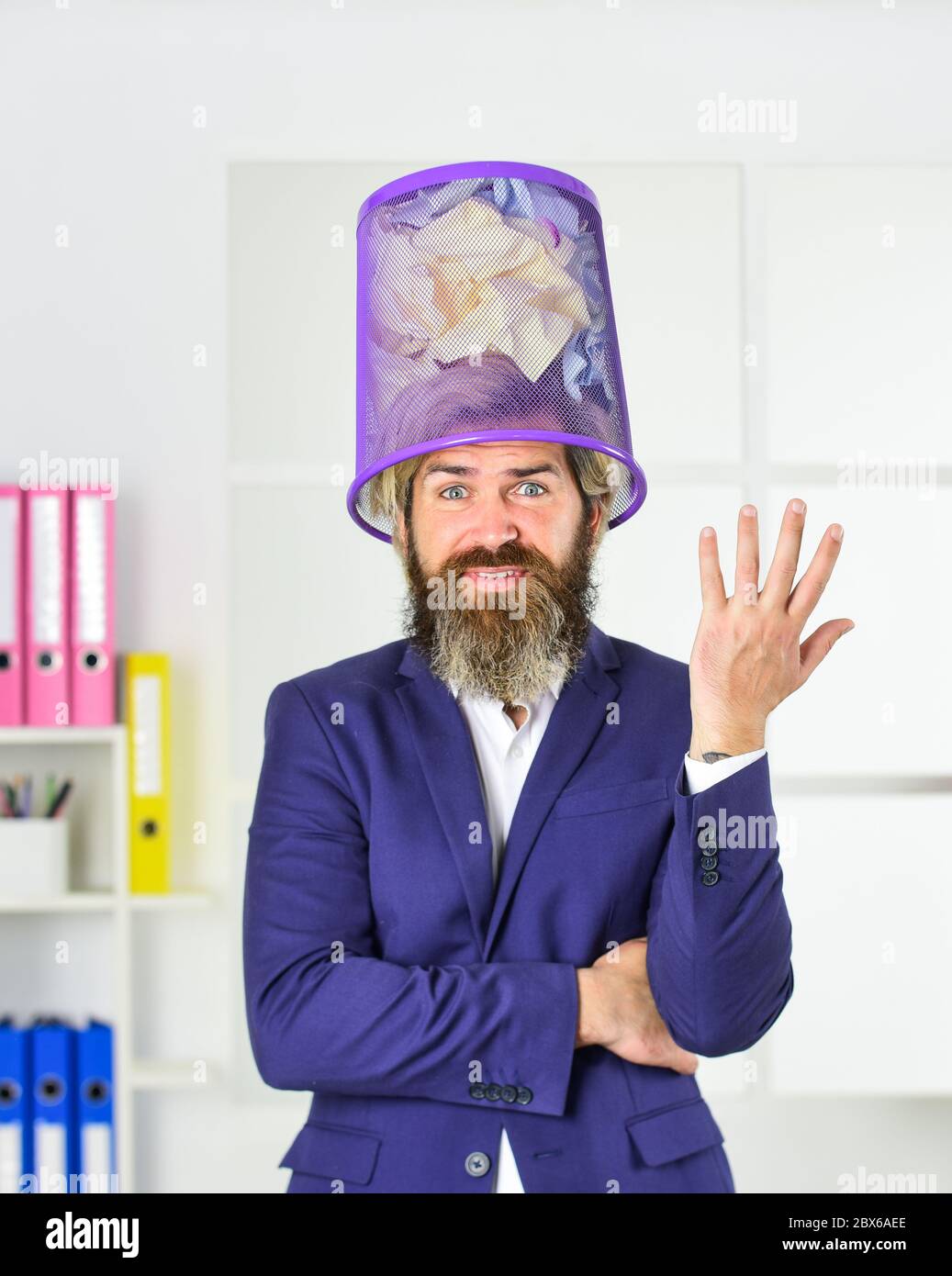 looking so funny. man in office look for lost note in paper bin ...