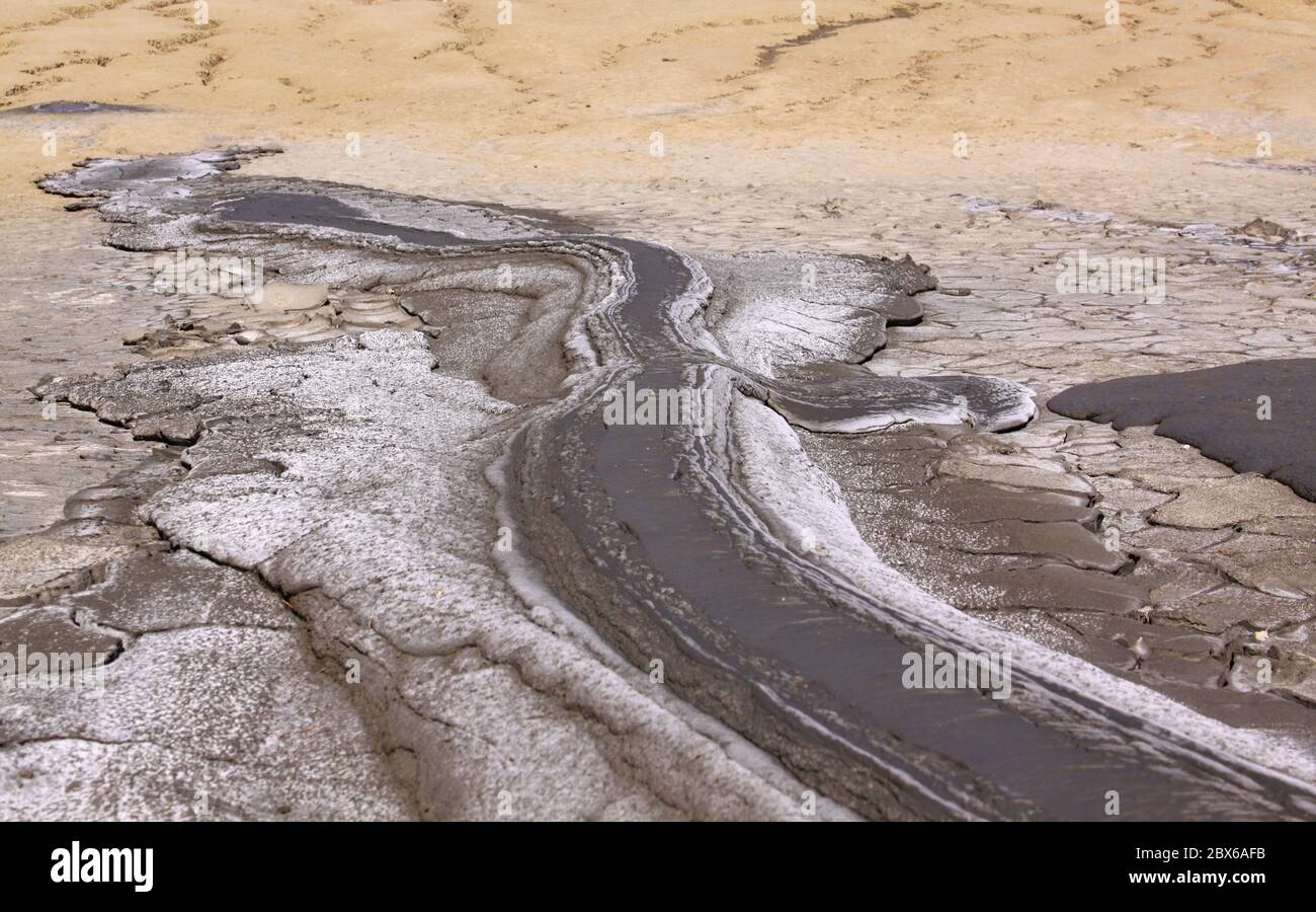 Mud lava flows downhill from mud volcano at Paclele Mari mud volcano in ...