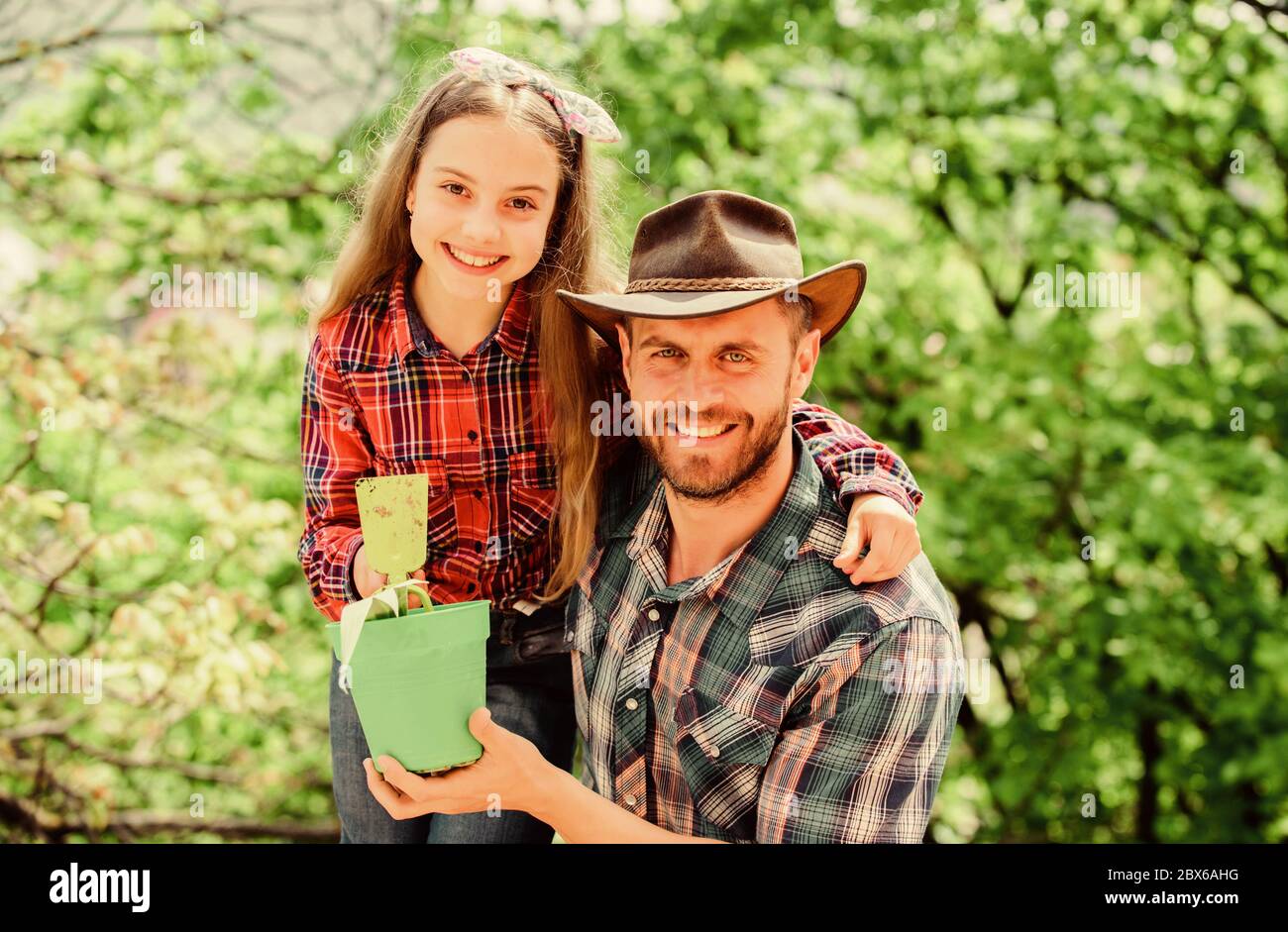 Family dad and daughter planting plants. Plant your favorite veggies. Planting season. Family ...