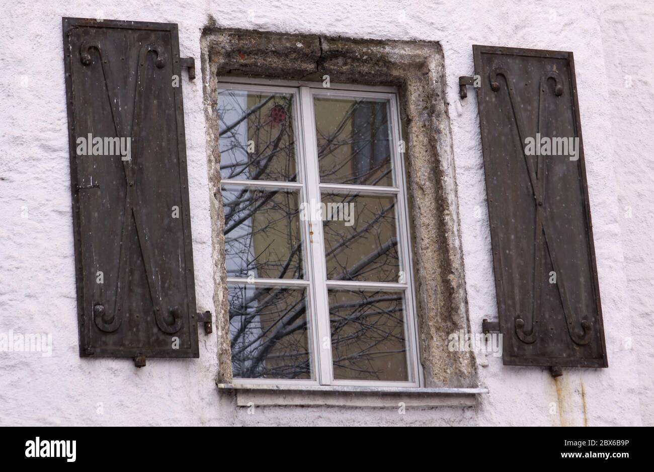 Medieval window of building with iron shades Stock Photo - Alamy