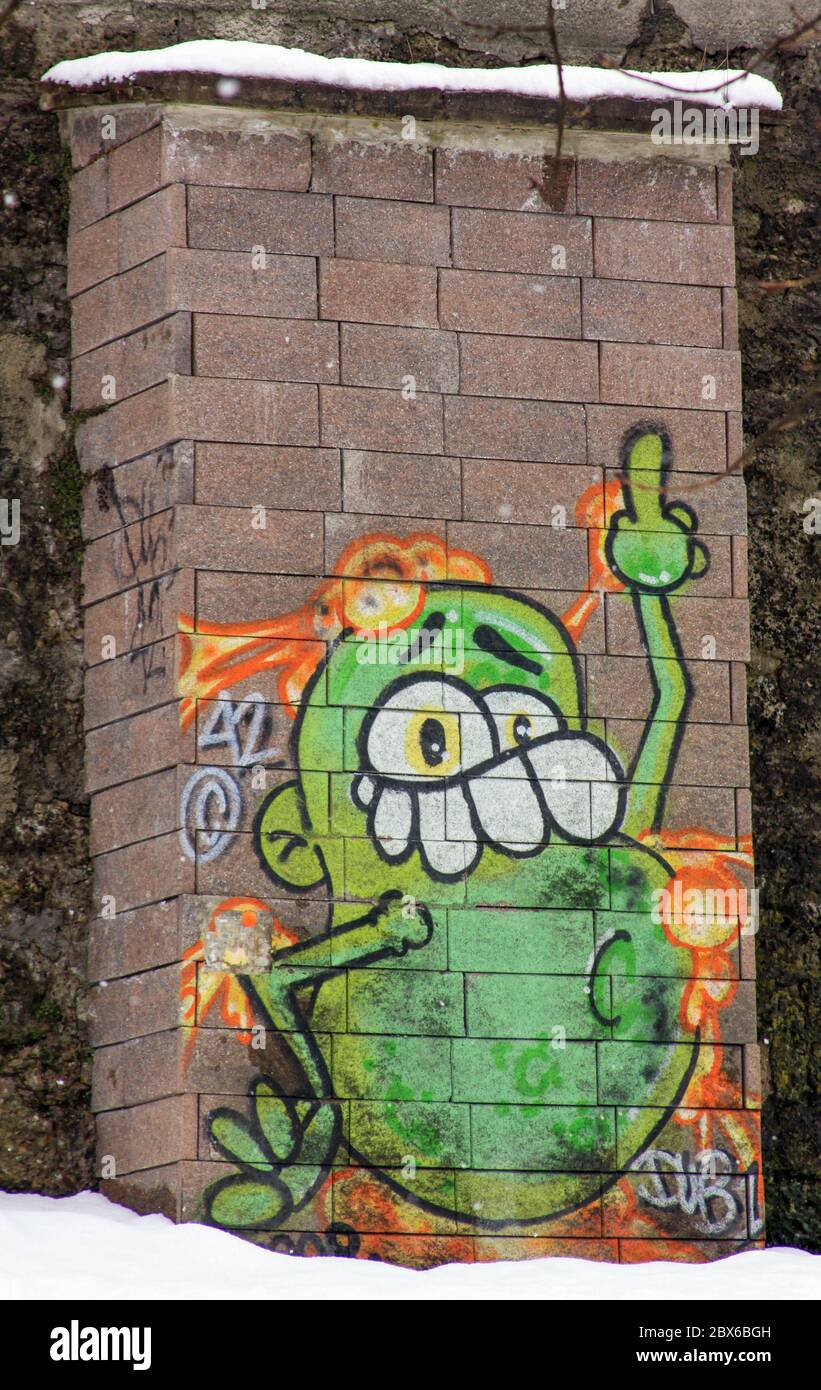 Funny green character graffiti painting on wall in Salzburg, Austria ...
