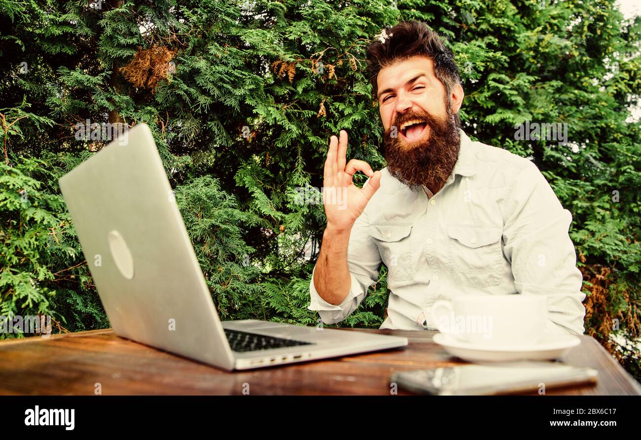 Drink coffee and work faster. Bearded man successful freelance worker ...