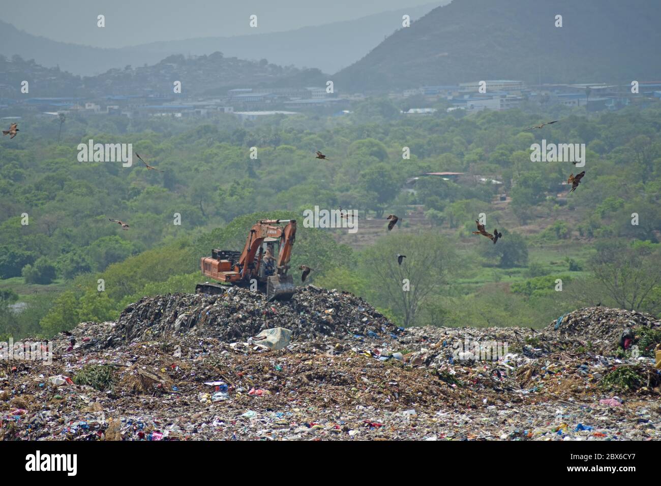 Thane, India. 05th June, 2020. A bulldozer gathers trash at Adharwadi ...