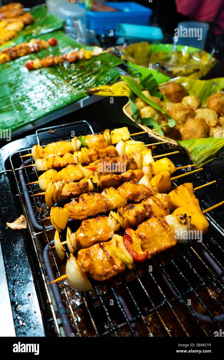 Asian food. Different mini barbecue counter at night street food market ...