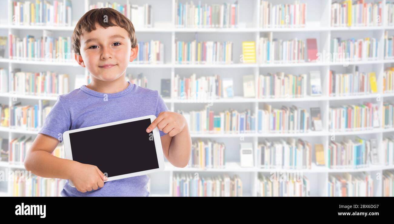 Boy child pointing at tablet computer library banner information ...