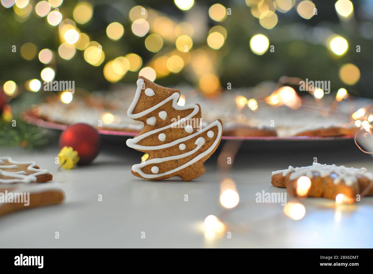 Christmas tree cookie. Christmas lights background Stock Photo - Alamy