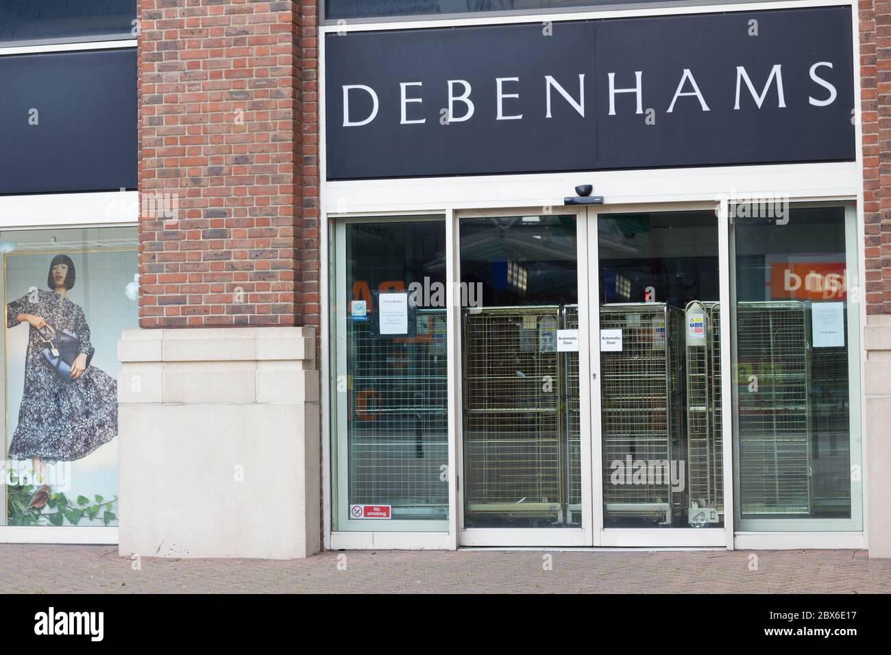 Entrance to Debenhams store is shut with trolleys behind glass doors at ...