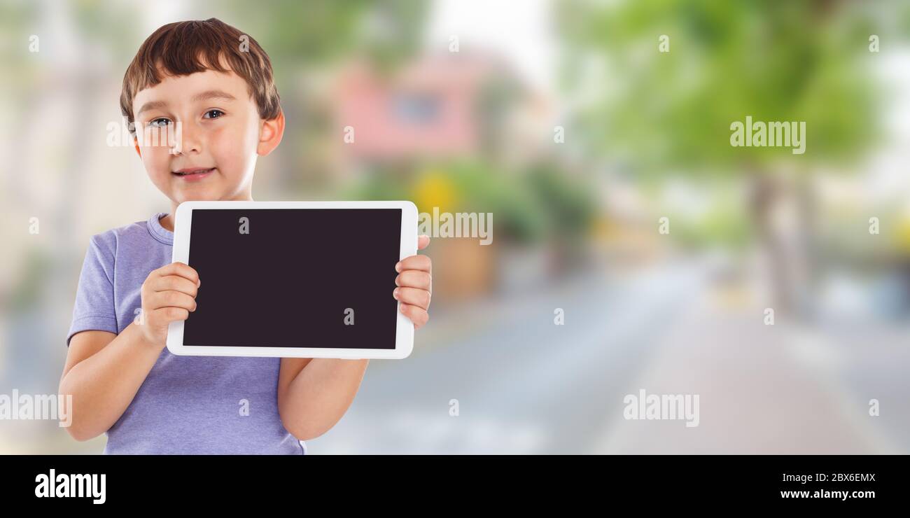 Boy child holding tablet computer town banner copyspace copy space ...