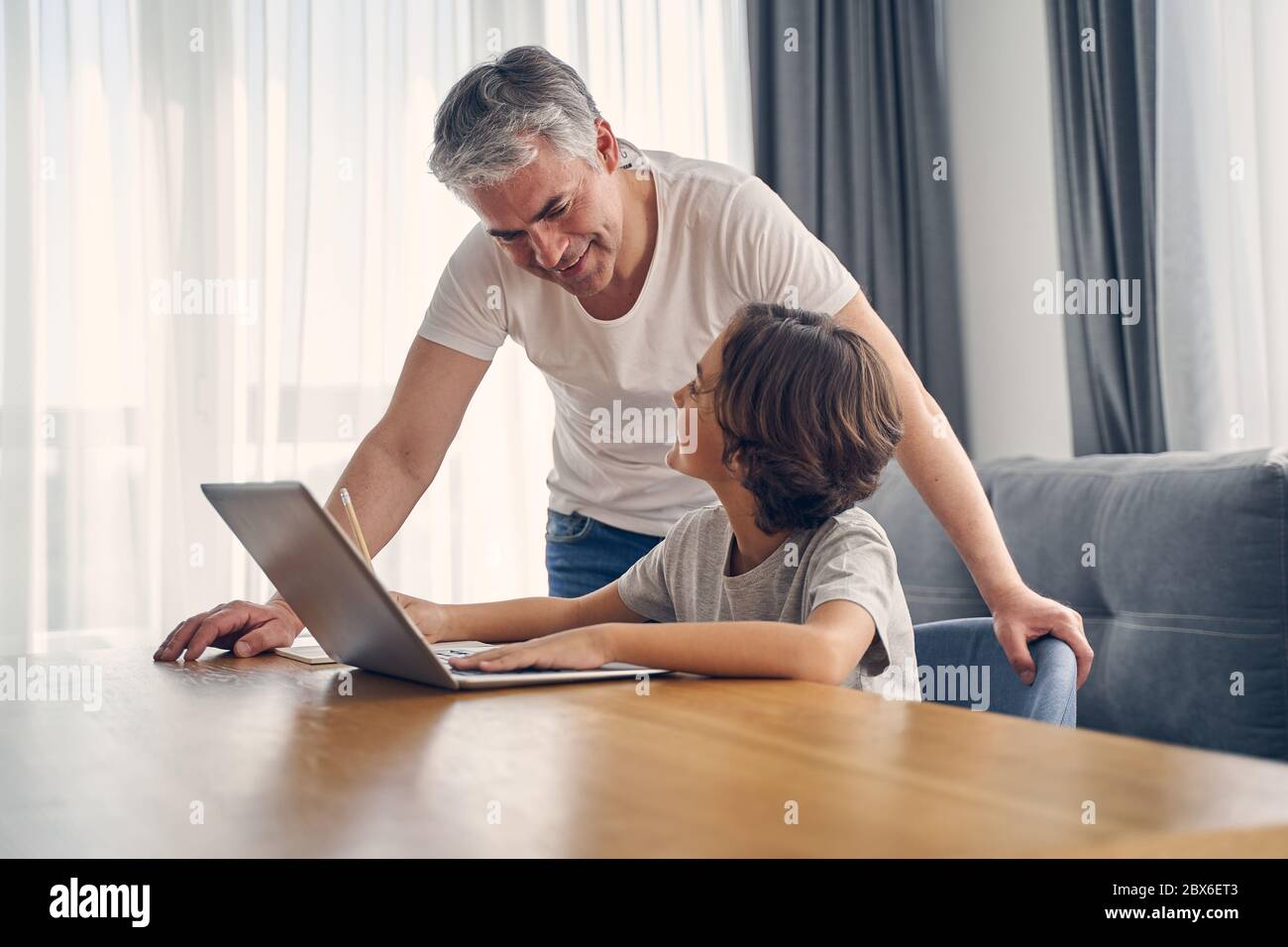 Happy parent and kid talking to each other Stock Photo - Alamy