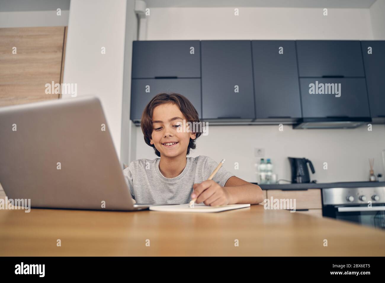Small child staying at home and studying Stock Photo - Alamy