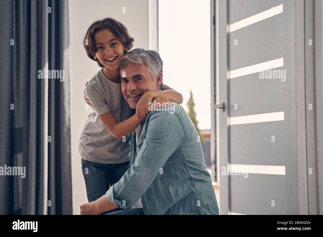 Happy dad and kid spending time together inside Stock Photo - Alamy