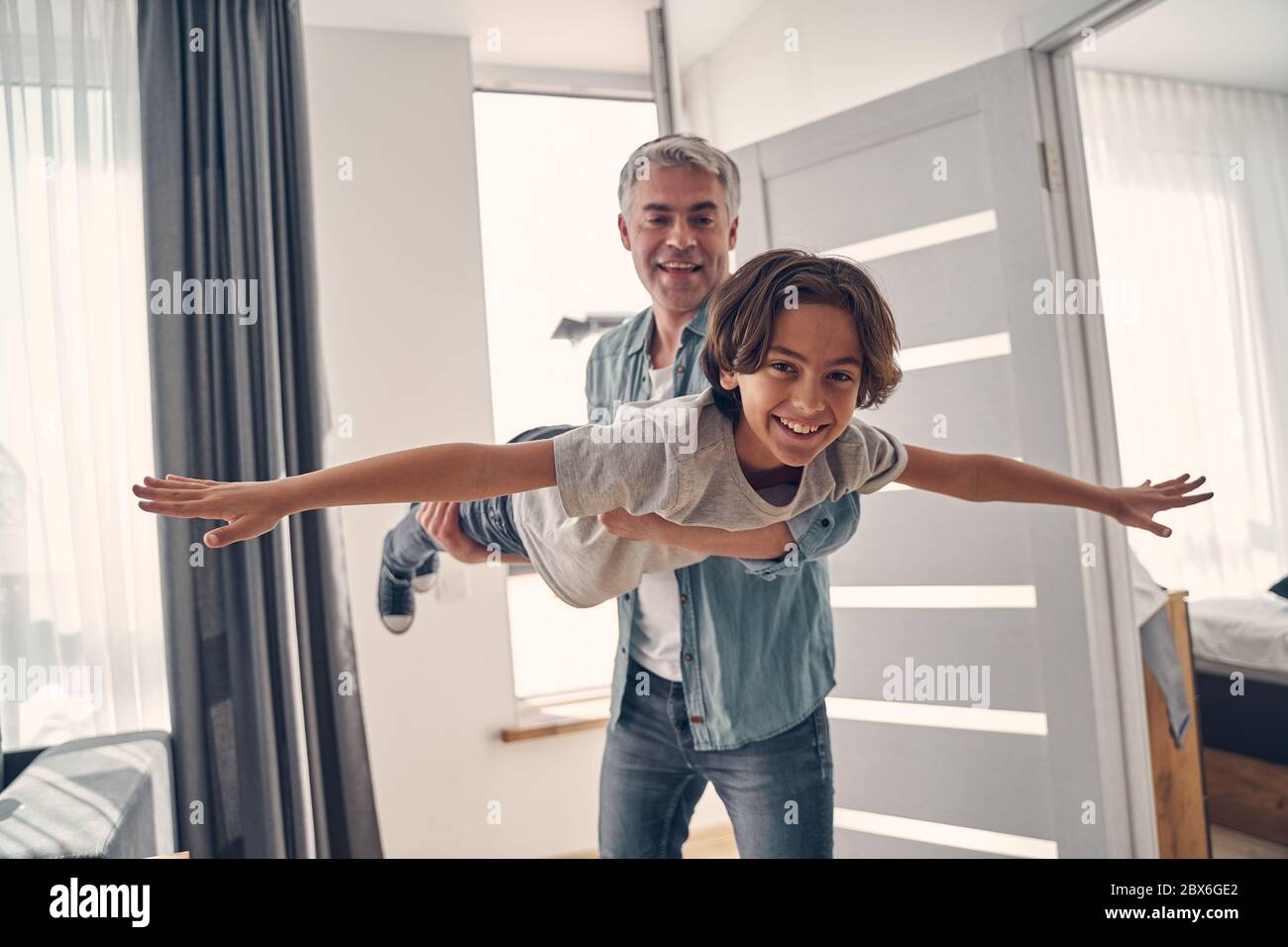 Handsome dad playing with his little child Stock Photo - Alamy