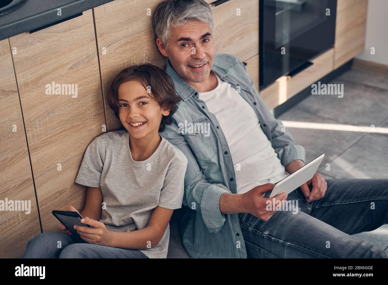 Smiling parent and kid spending nice time together Stock Photo - Alamy