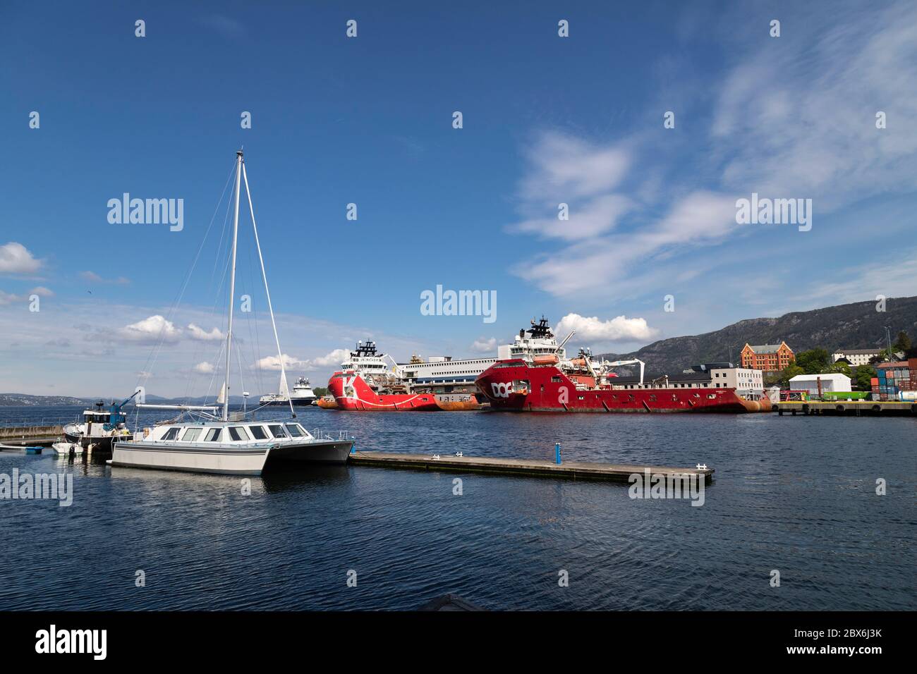 Sailing vessel catamaran Catalibré. In background, offshore vessels ...