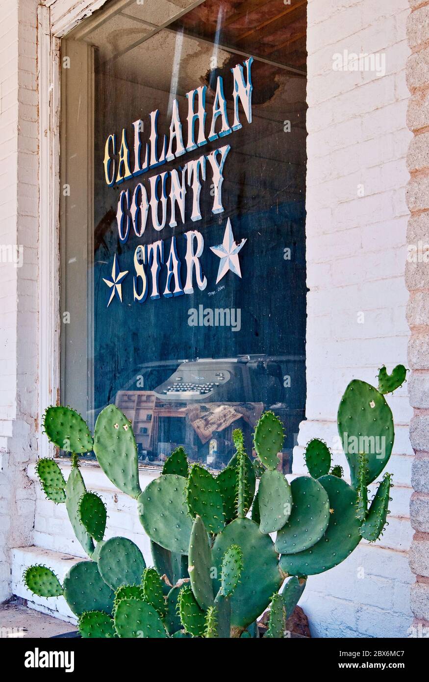 Prickly pear cactus at window of newspaper office (now closed) at ...