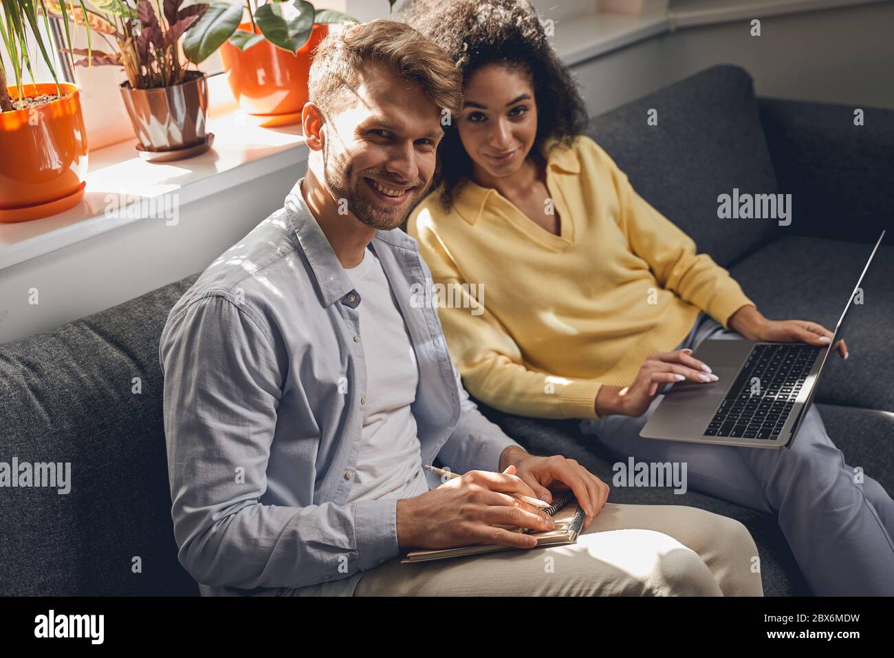 Two office workers sitting on the couch Stock Photo - Alamy