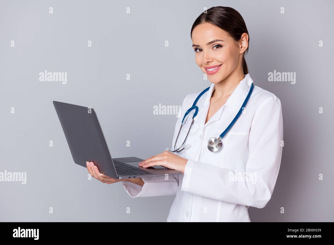 Photo of professional family doc lady browsing modern technology ...