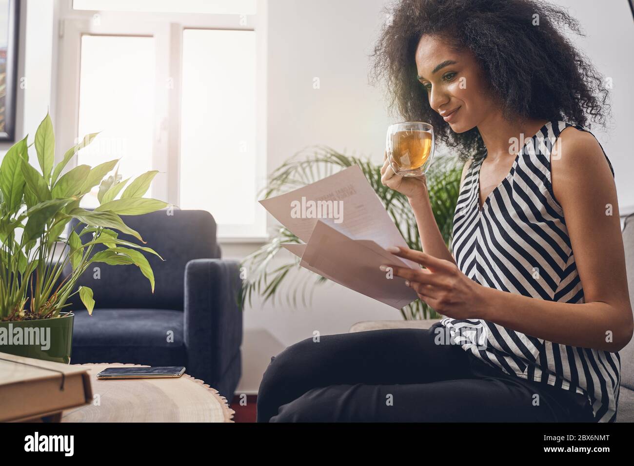 Woman looking through papers hi-res stock photography and images - Alamy
