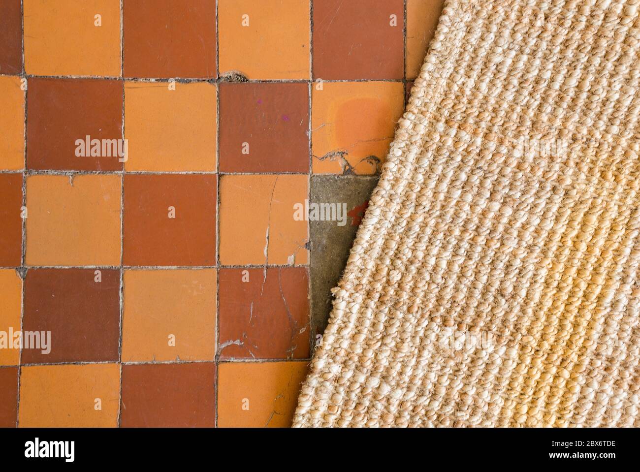 handmade carpet on an old retro tiled floor, carpet on the floor Stock ...