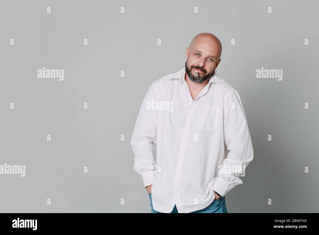 Handsome middle-aged man on grey background looking at camera. with ...