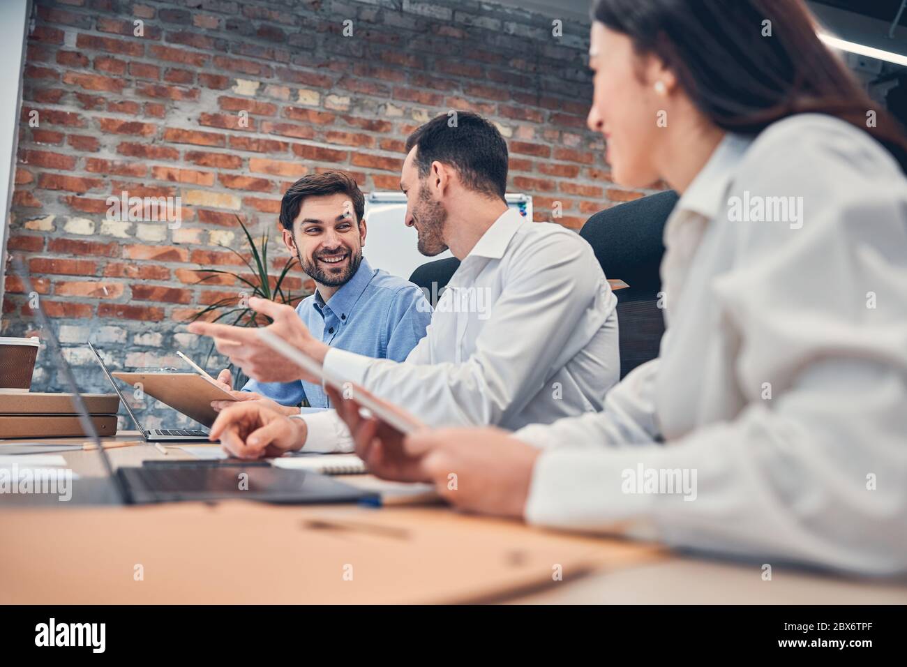 Happy colleagues are working in modern office Stock Photo - Alamy