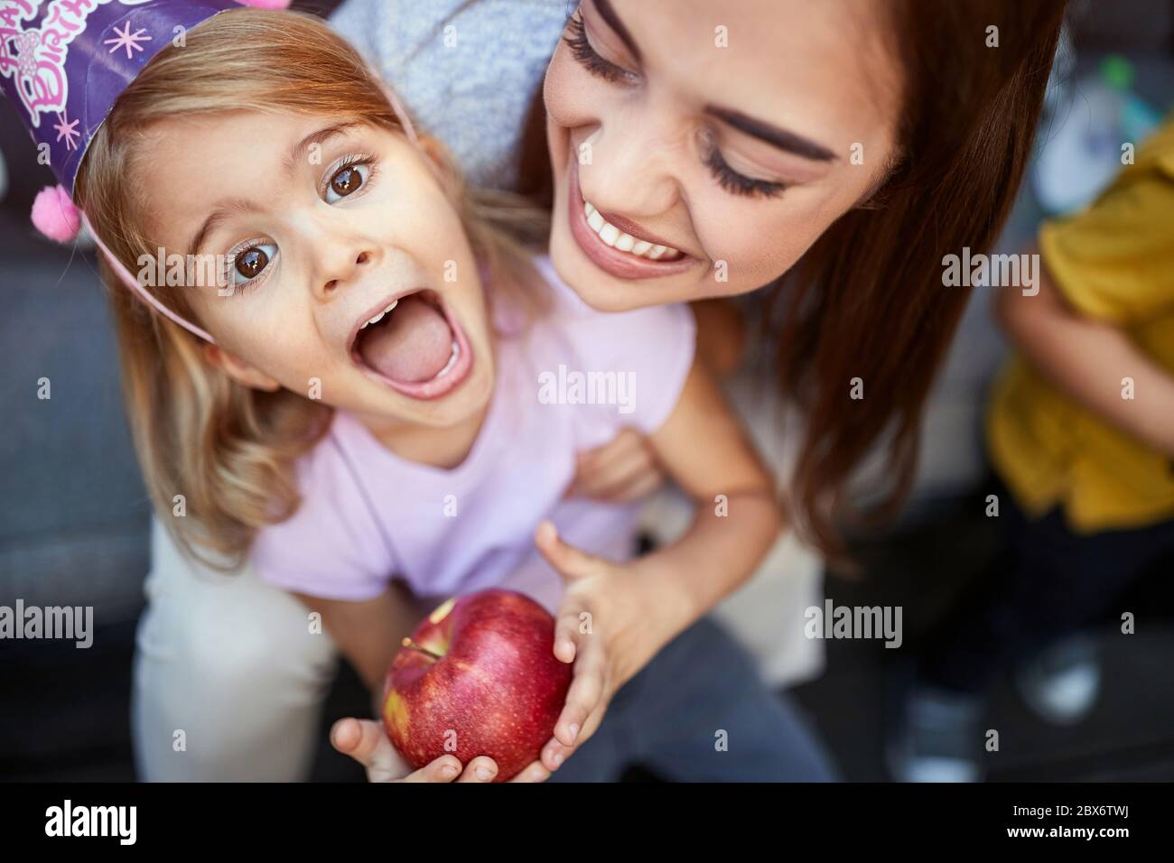 Top view of mother with daughter with apple Stock Photo - Alamy