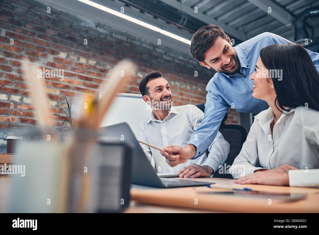 Co workers talking office desk hi-res stock photography and images - Alamy