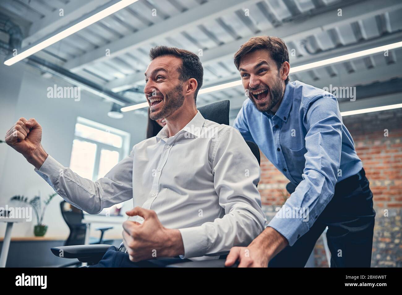 Excited colleagues enjoying funny competition in office Stock Photo - Alamy