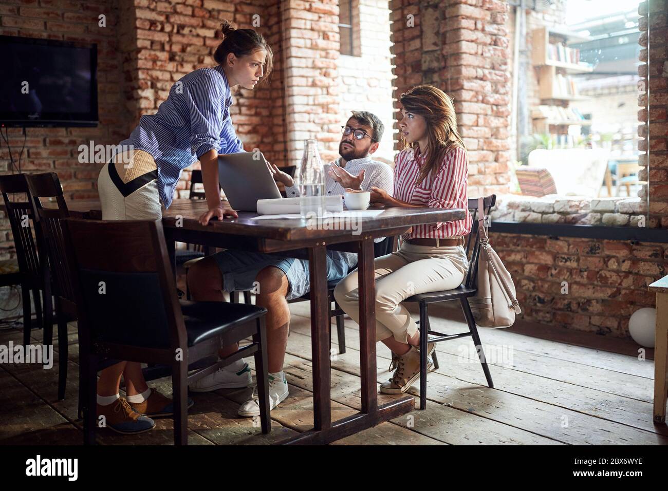 angry woman leaned across the table in cafe, finding her husband ...