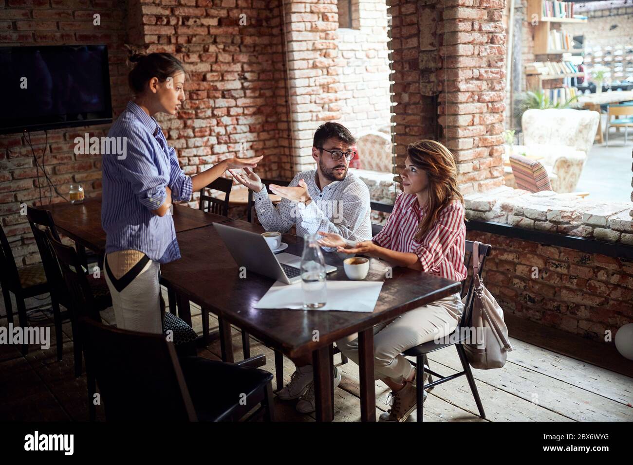 young couple sitting in cafe, arguing with waitress. issue, conflict ...