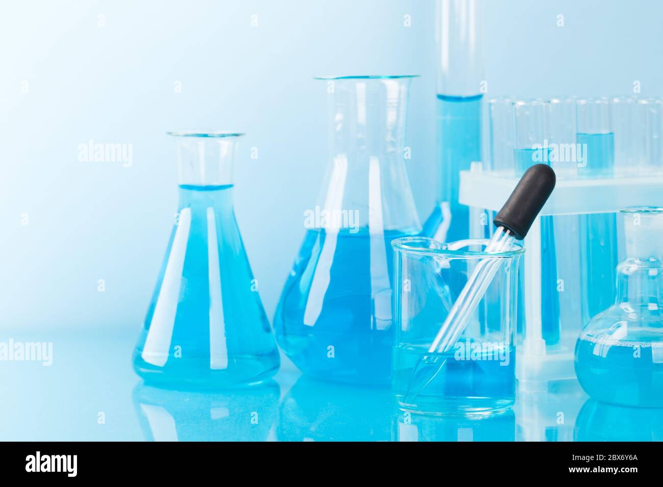 Laboratory glassware with a pipette and test tubes. scientific ...