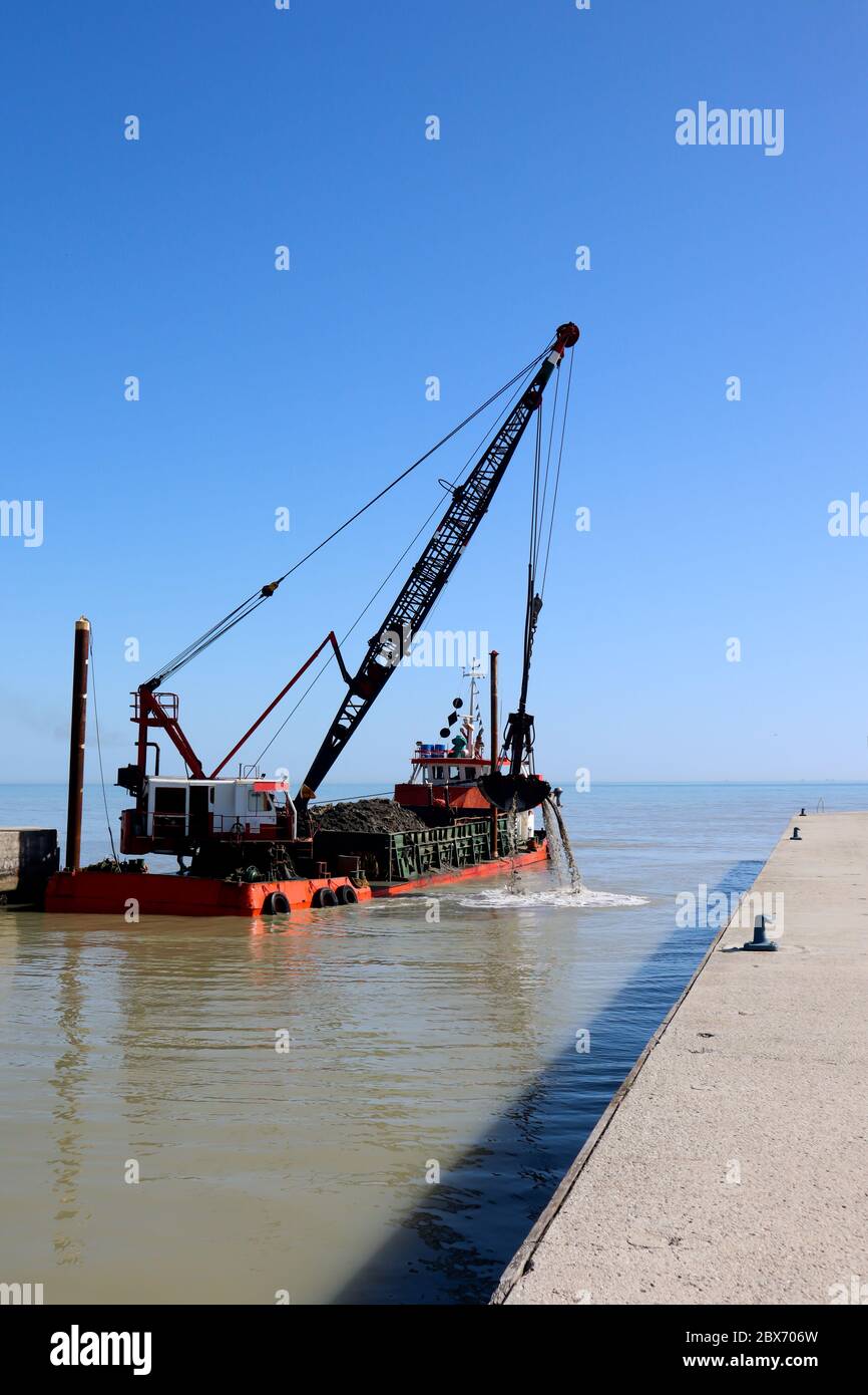 Large Industrial floating sea crane unloading sand, sand-cleaning red ...