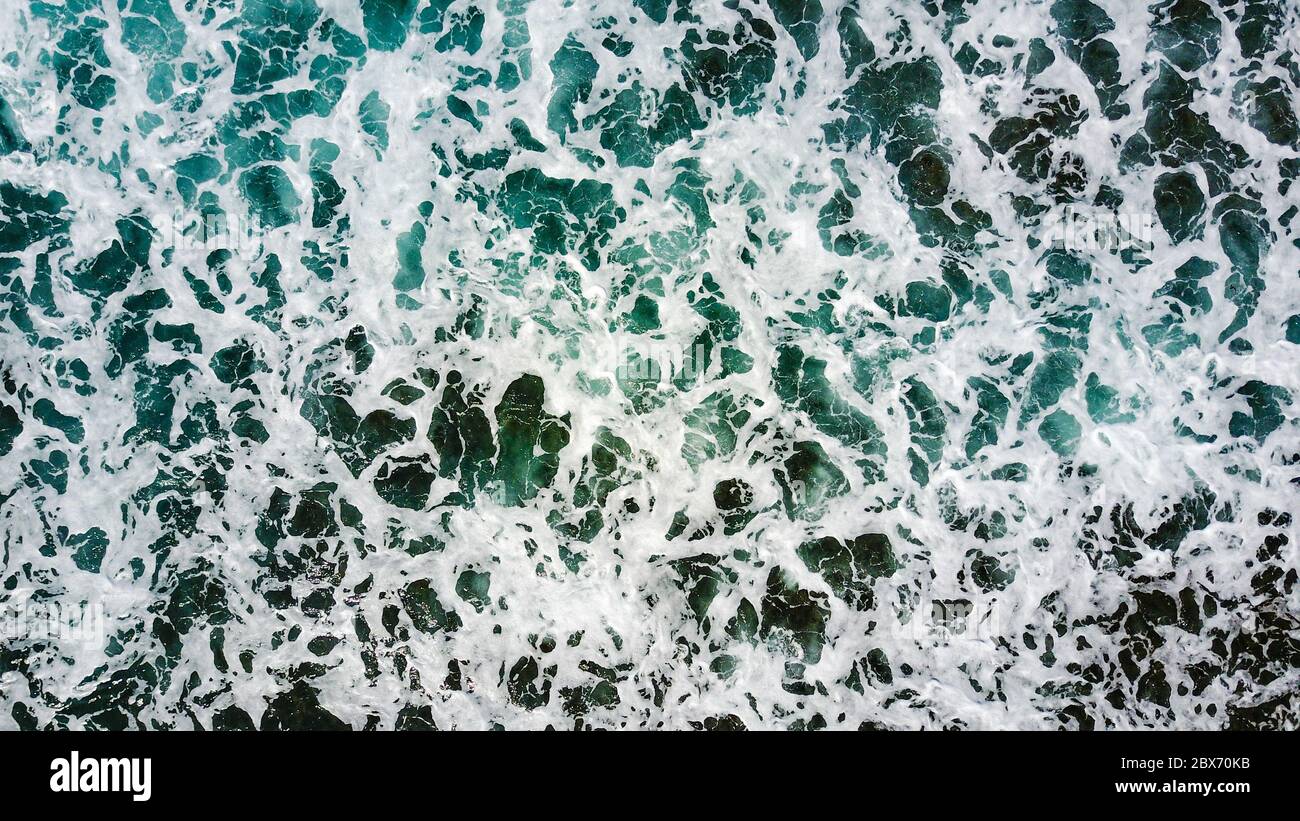 Aerial view of waves from above creating the natural abstract pattern ...