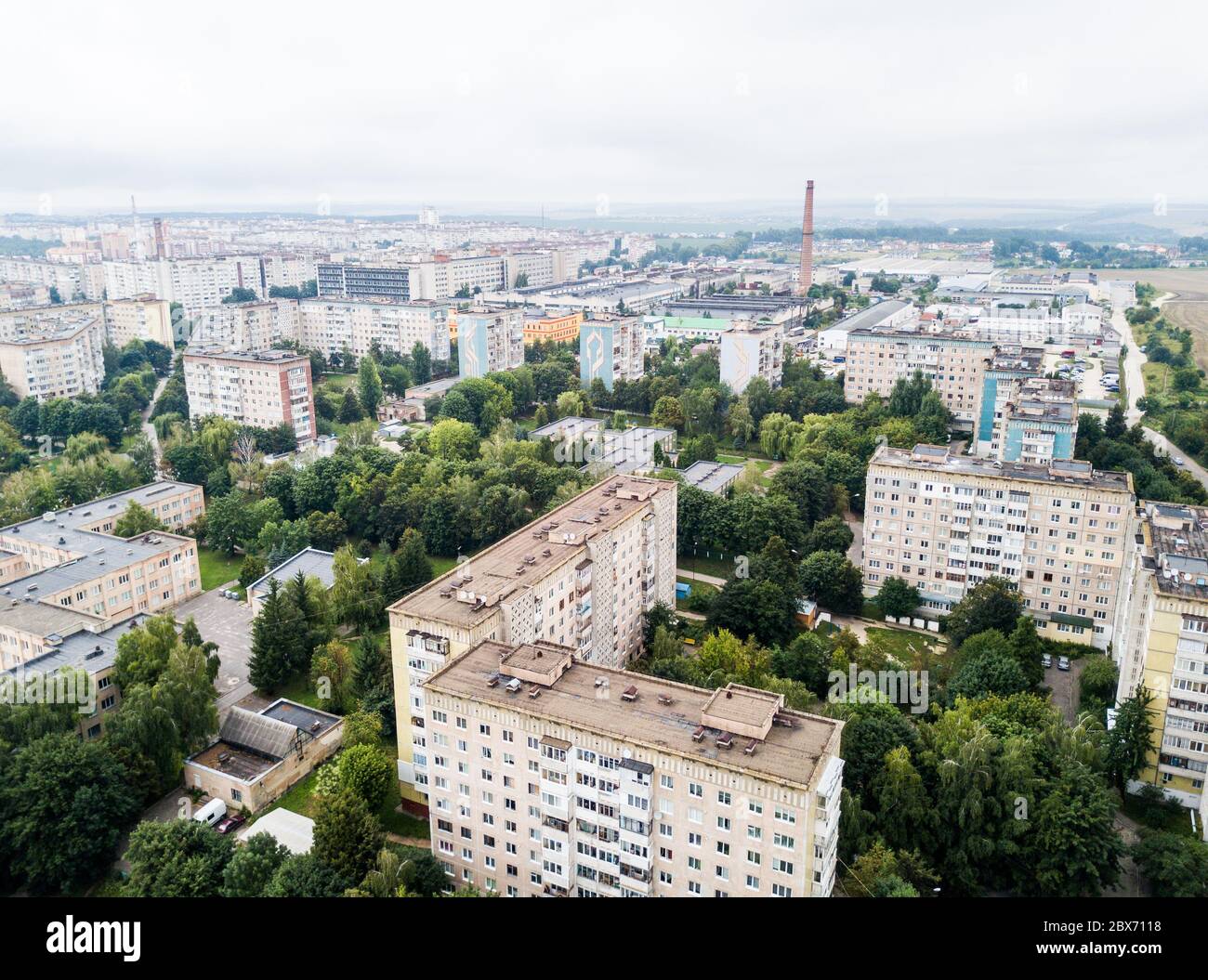 Aerial view of town with socialist soviet panel building at cloudy day ...