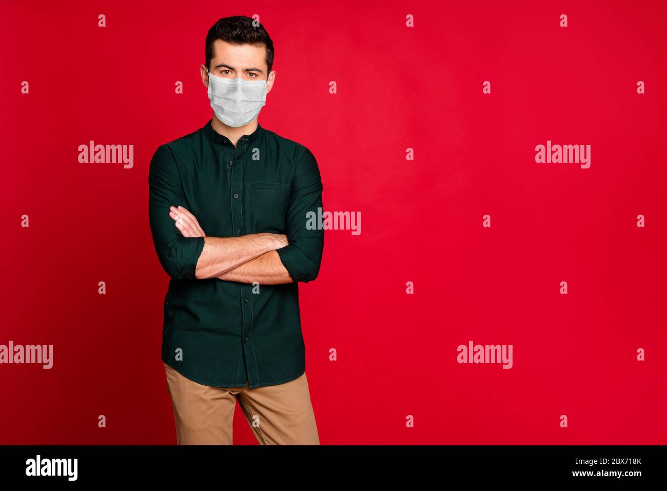 Portrait of his he nice attractive guy wearing safety mask folded arms ...