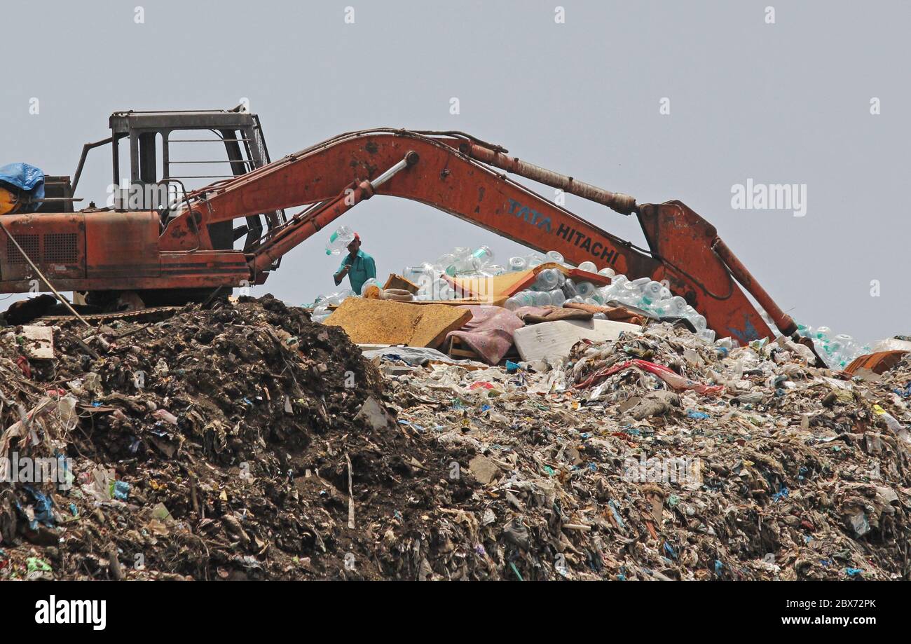 A man is seen throwing plastic waste from behind a stationary crane at ...