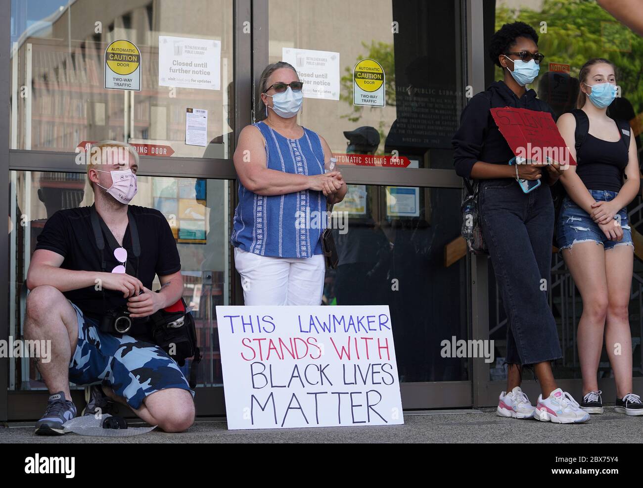 U.S. Representative Susan Wild (PA-07), center, stands with protesters ...