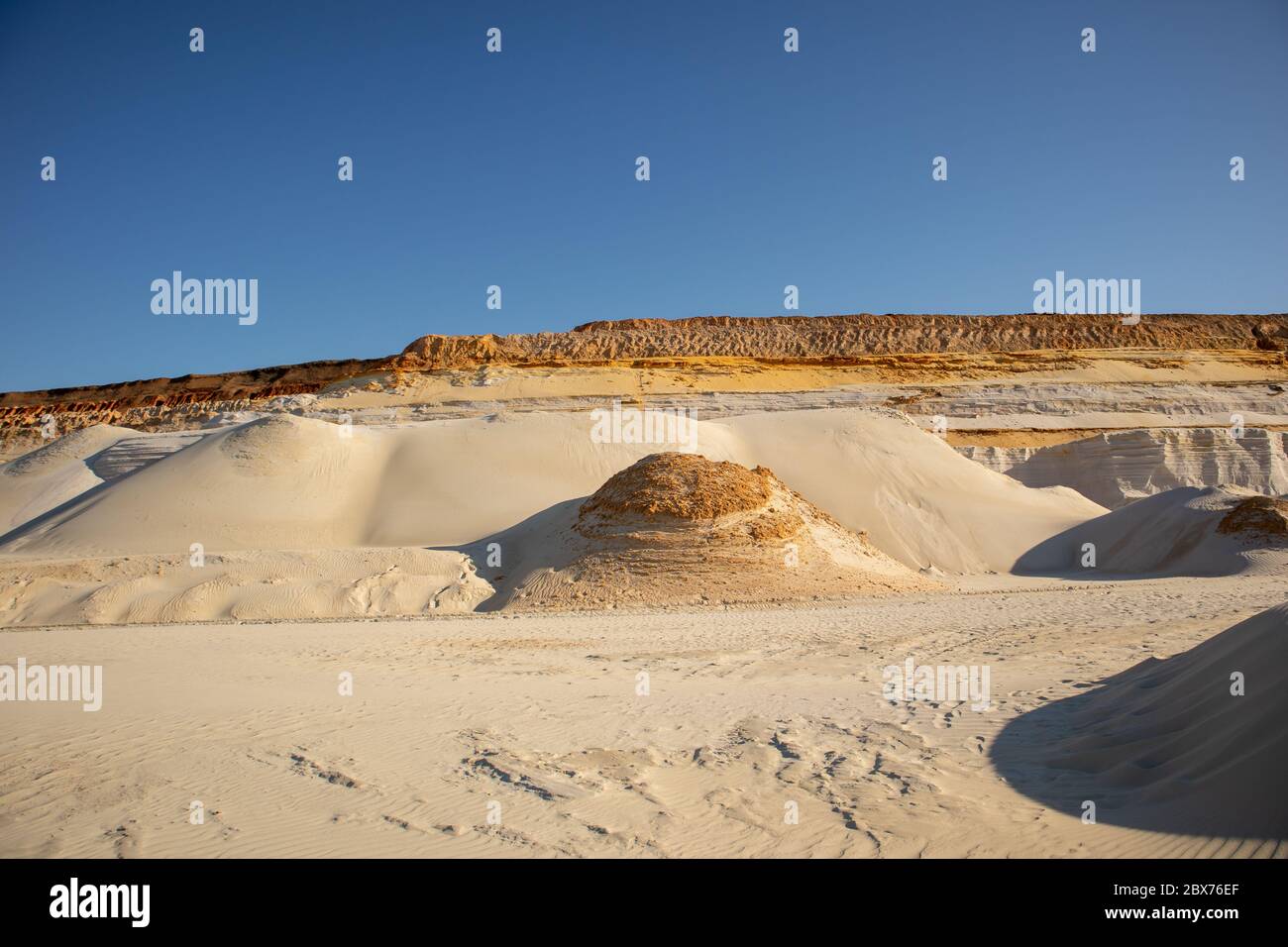 White sand and blue sky. Embossed sand mountains of white sands. Desert ...
