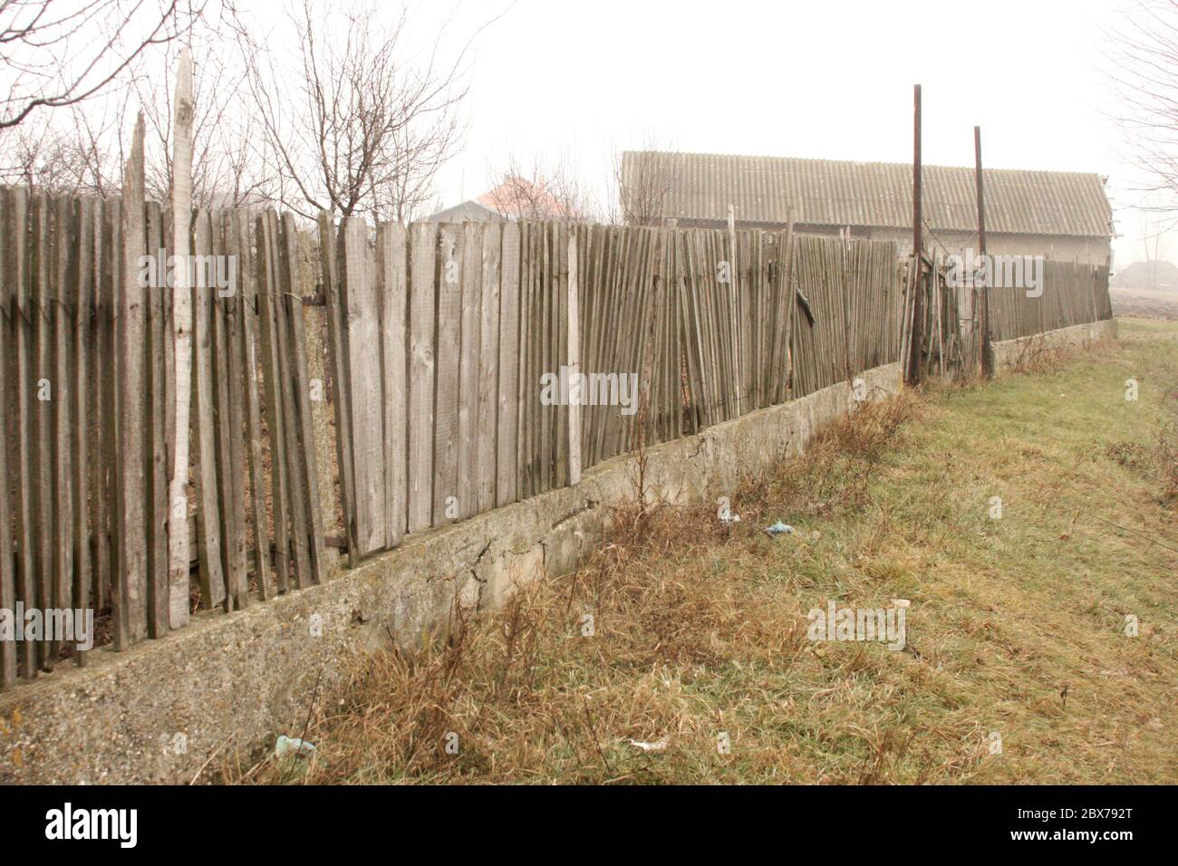 Unkempt traditional wooden fence around property in Romania's ...