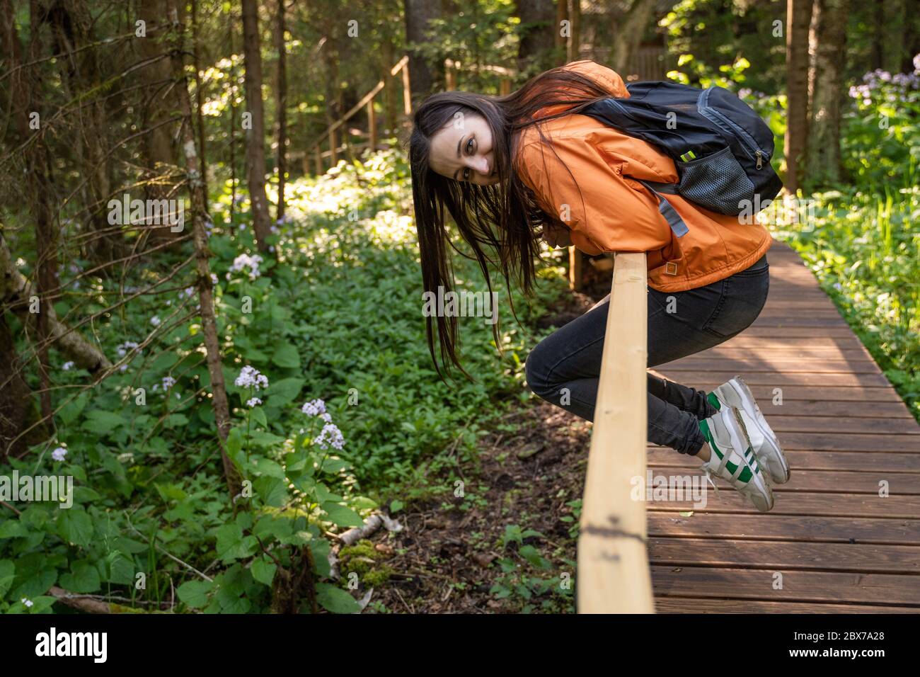 Young girl having fun in a funny pose hanging on the railing Stock ...