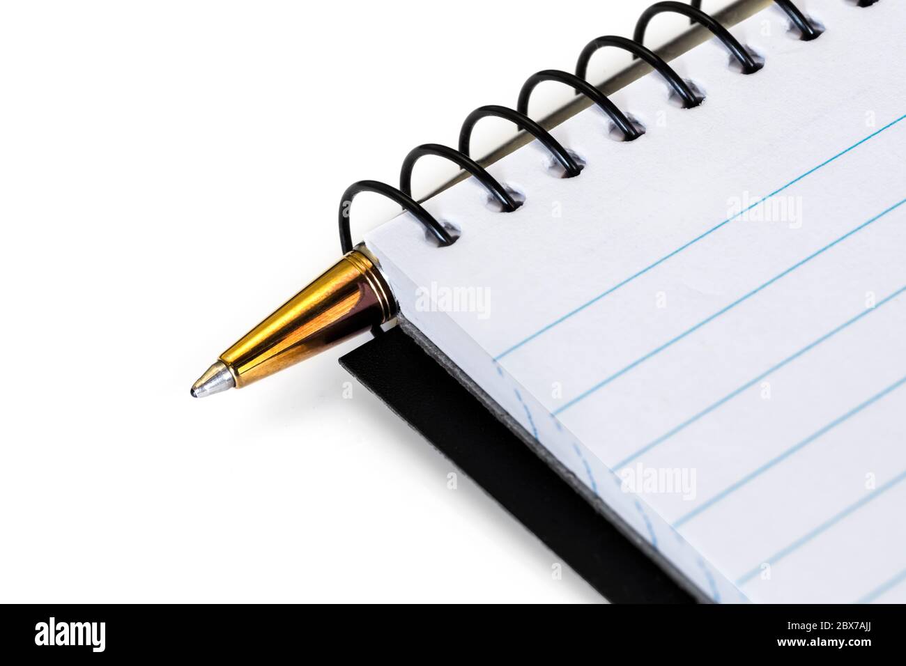 Spiral notebook with gold ballpoint pen, over white. Closeup view Stock ...