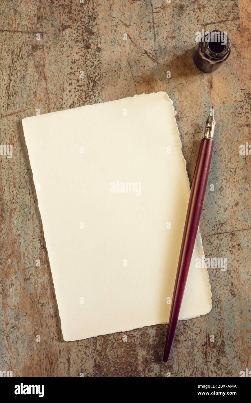 Nib pen and inkwell with blank vintage paper. Top view, on rustic ...