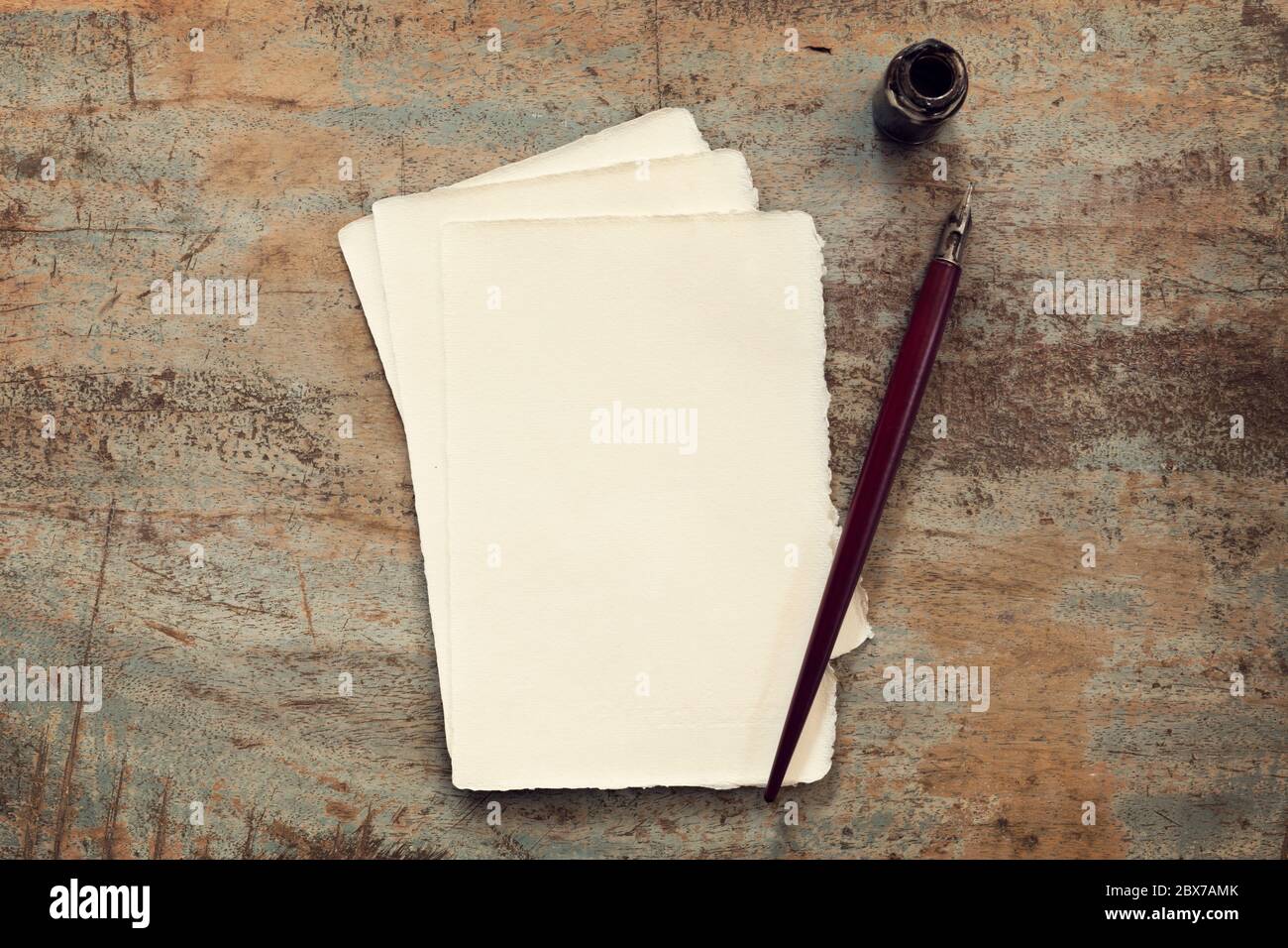 Nib pen and inkwell with blank vintage paper. Top view, on rustic ...